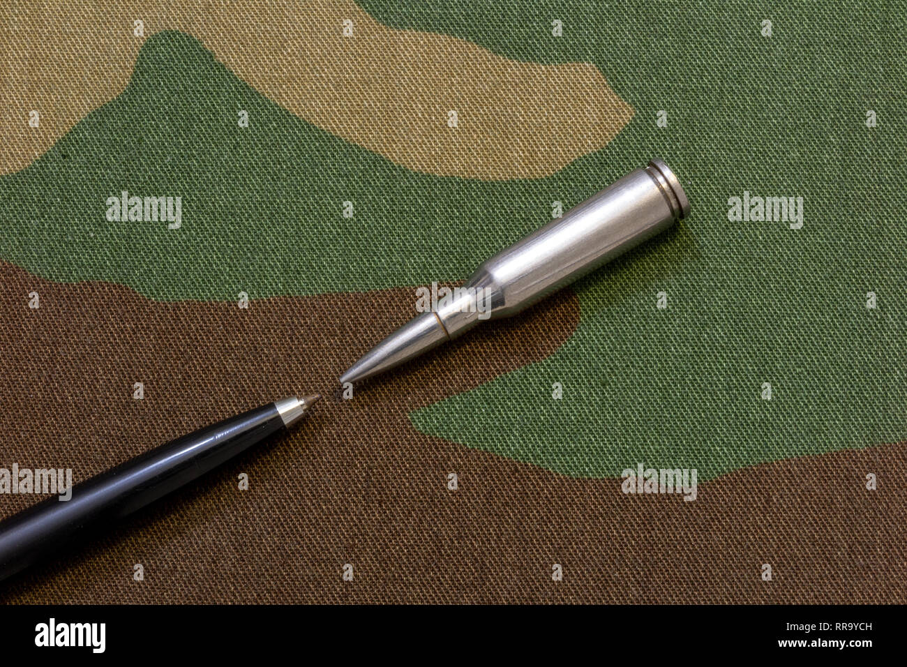 Silver rifle bullets against pen - a press freedom concept Stock Photo ...