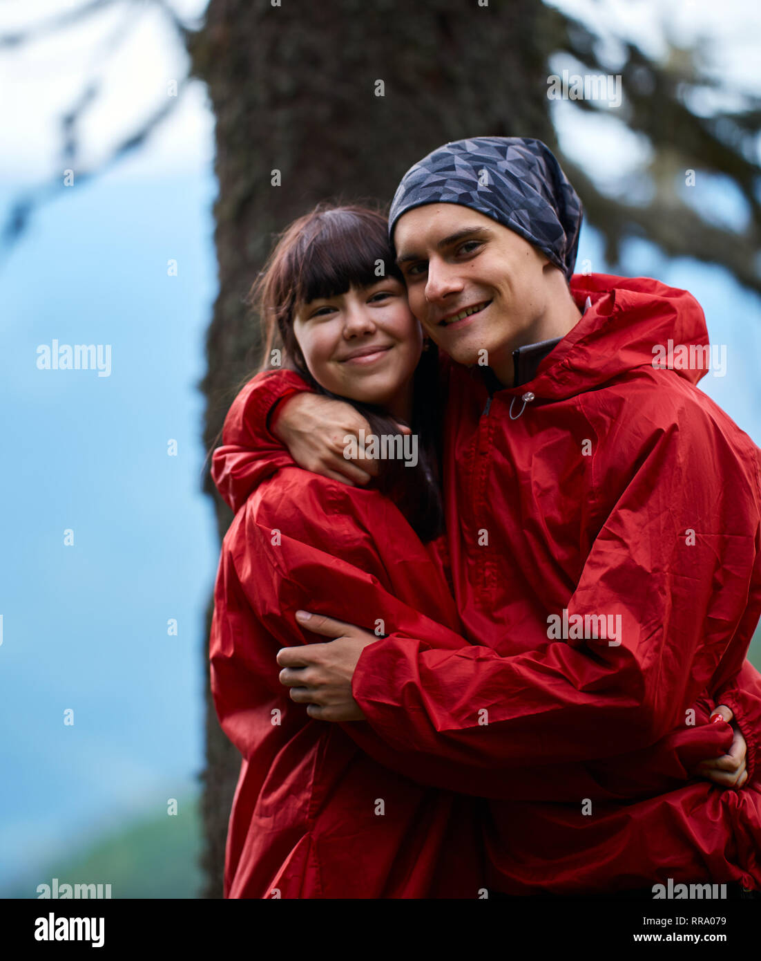 Young couple in rain coats hiking in the highlands Stock Photo - Alamy