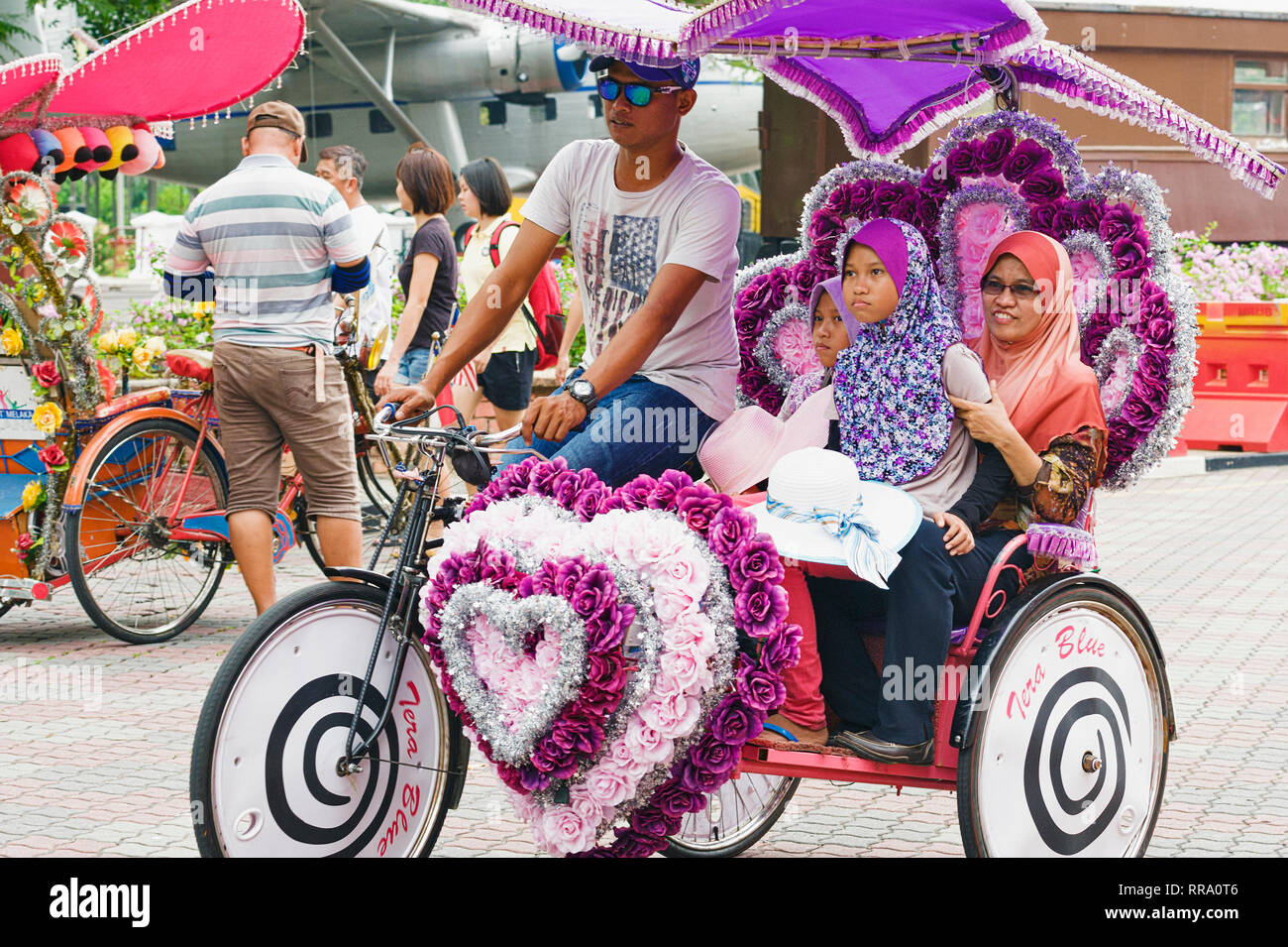 the colorful trishaws, a form of bicycle-powered rickshaw, that cruise ...
