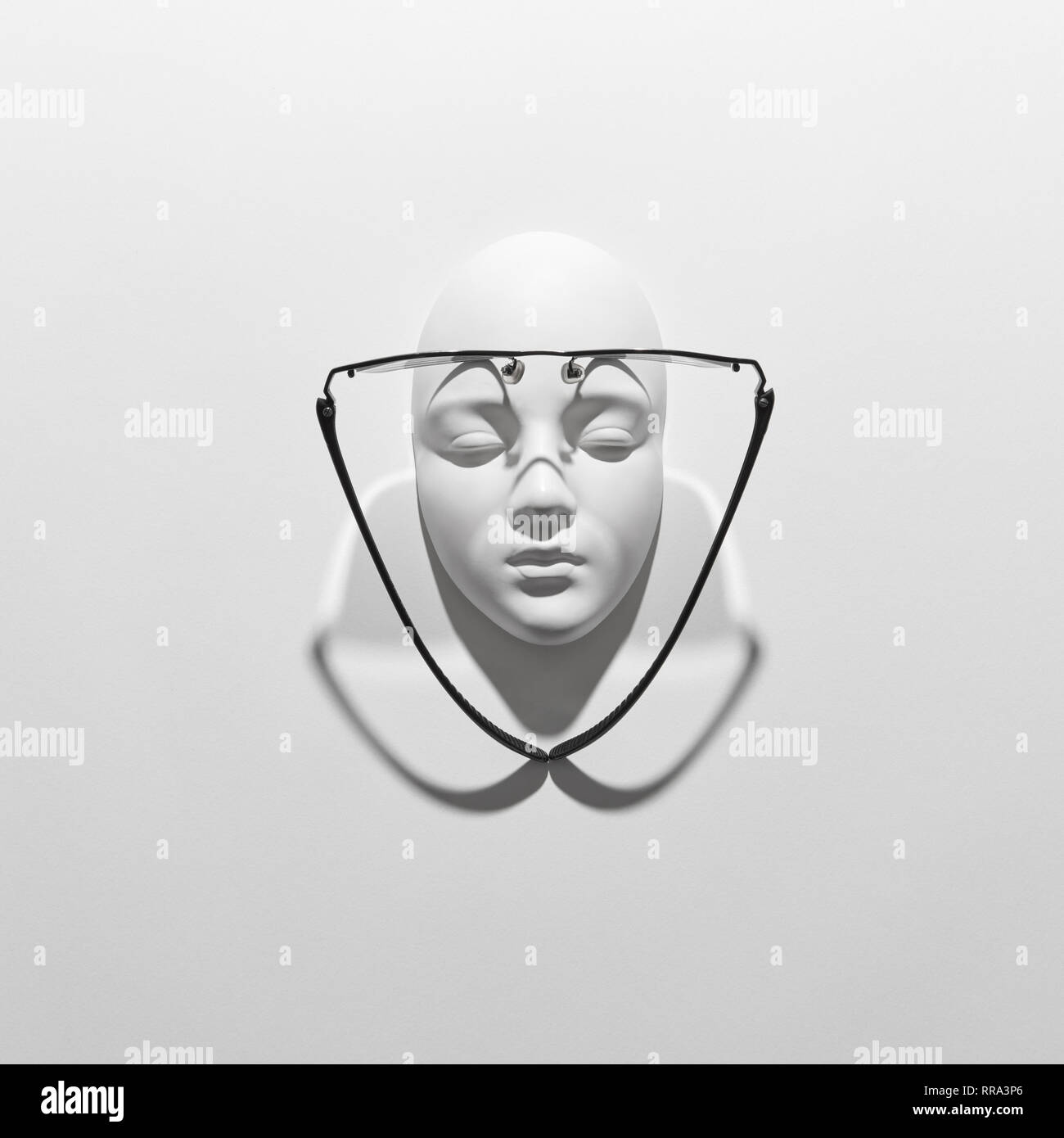 Gypsum face mask with elegant glasses above it on a white background ...