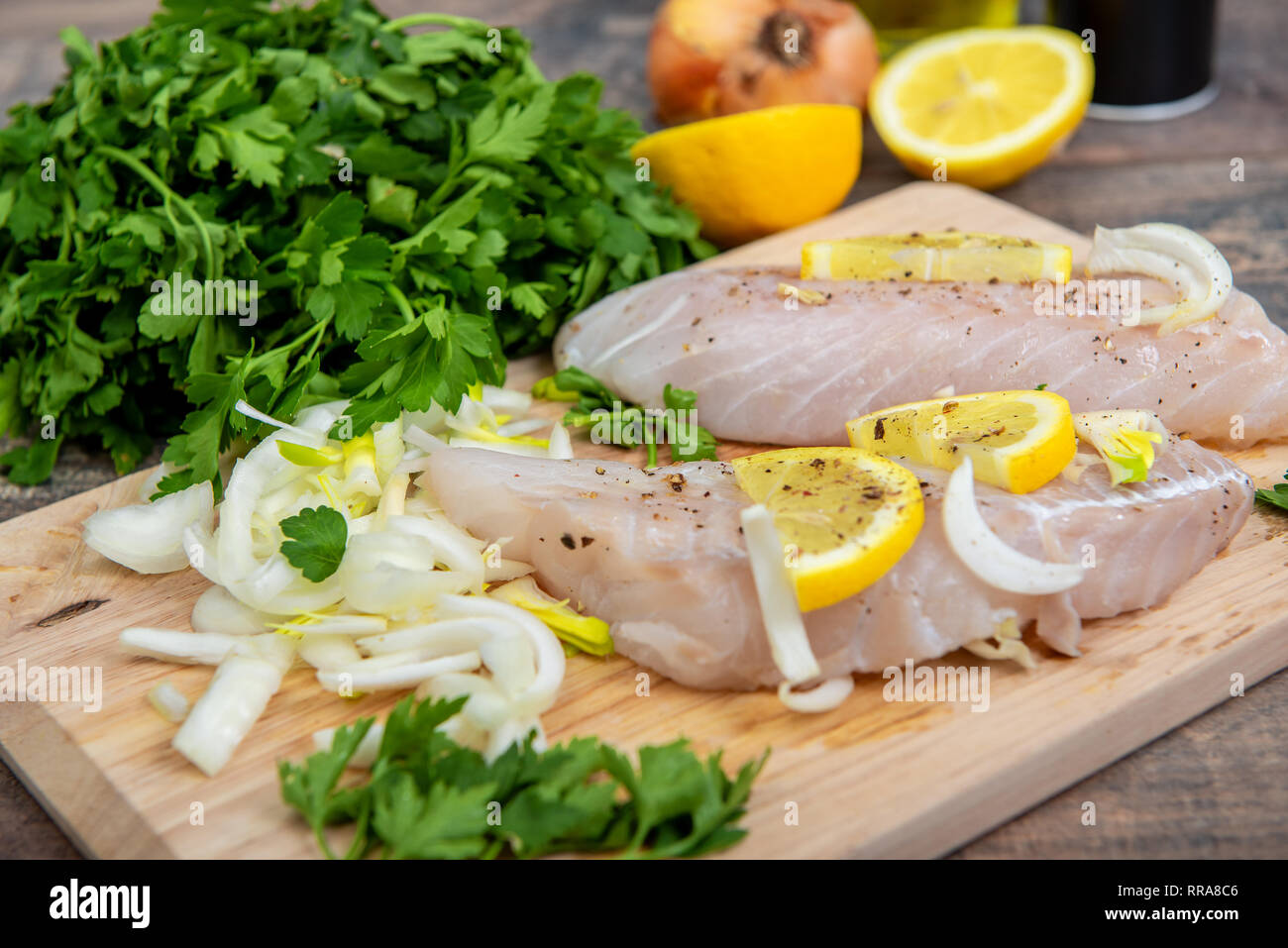 Fresh fish, a raw cod fillets with addition of herbs and lemon Stock ...