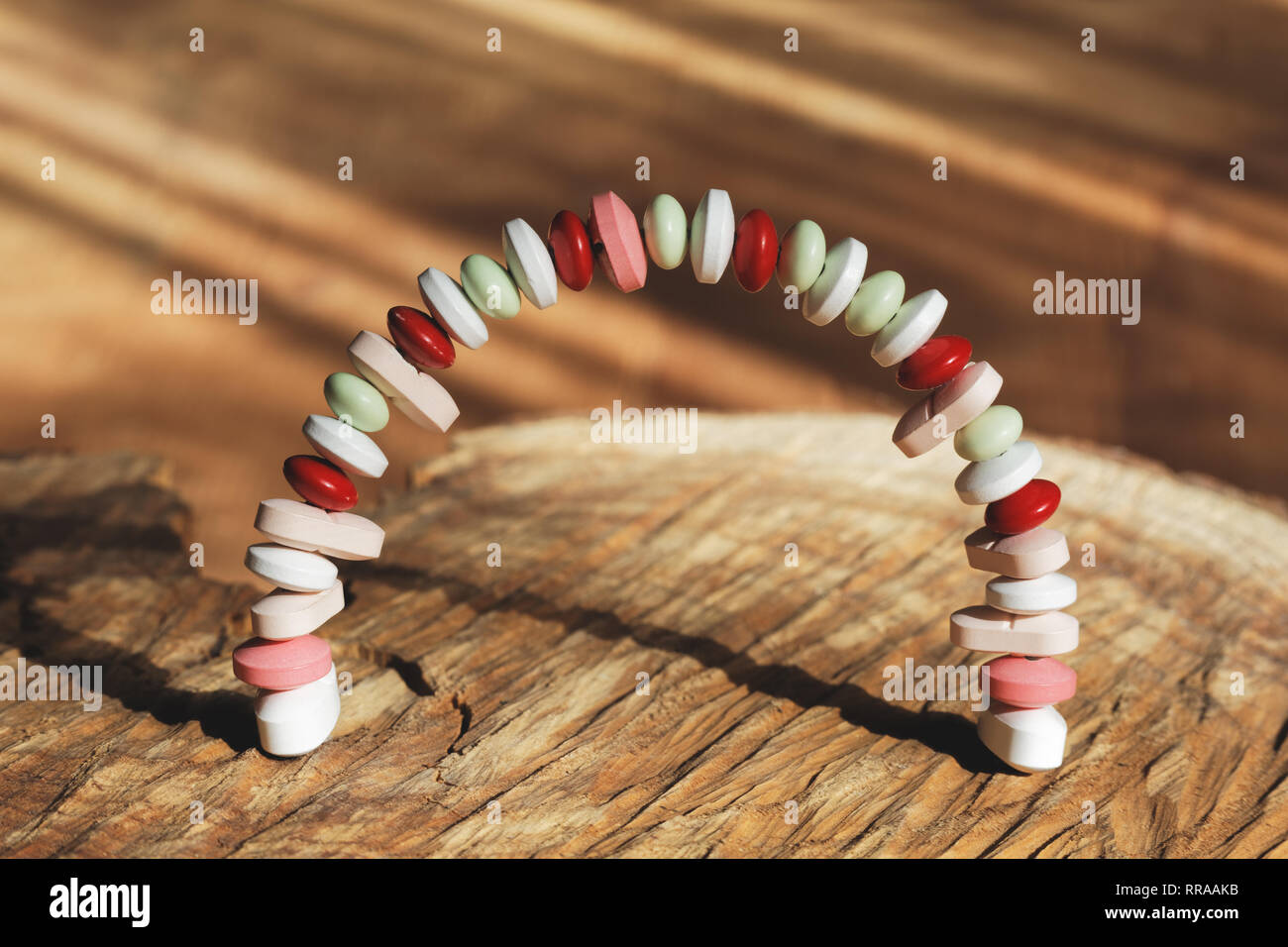 Tablets pills addiction concept formed in arch on natural wooden ...
