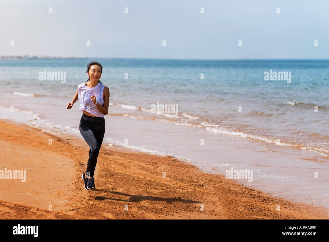 Running sun beach hi-res stock photography and images - Alamy