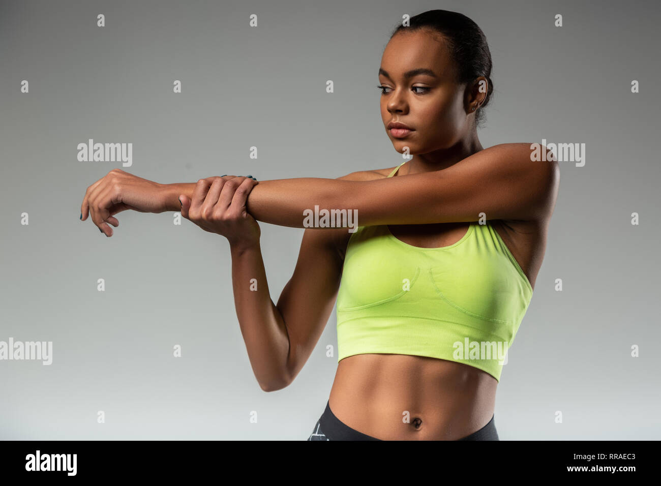 Attractive brunette girl stretching her both arms Stock Photo - Alamy