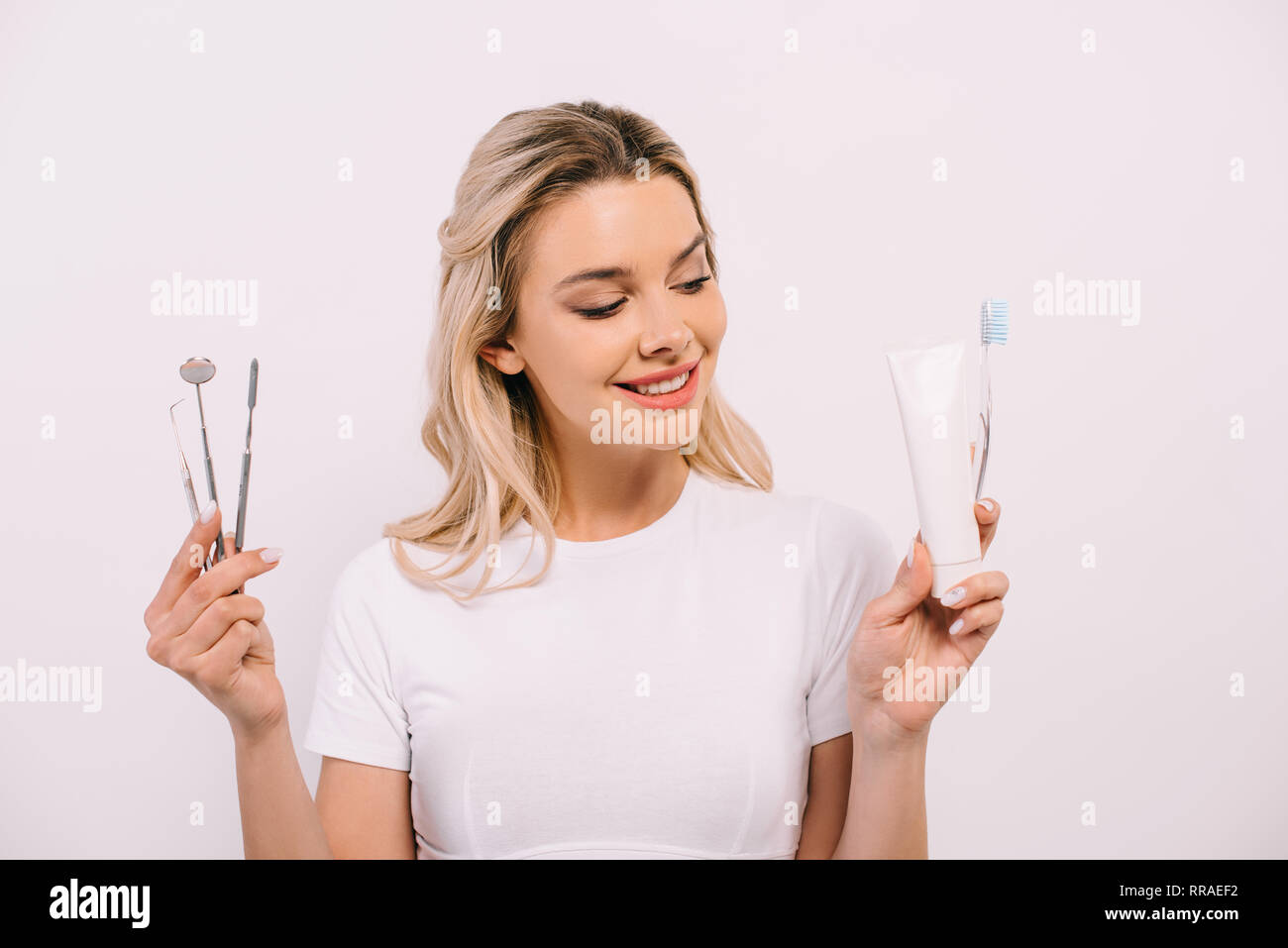 beautiful smiling woman holding toothpaste, toothbrush and dental ...
