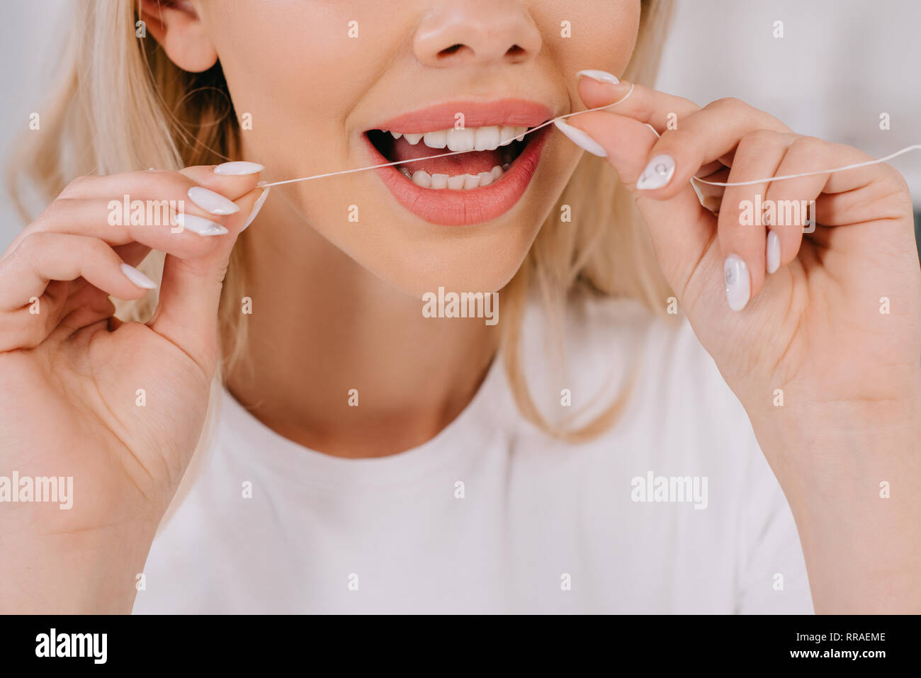 Woman flossing teeth hi-res stock photography and images - Alamy