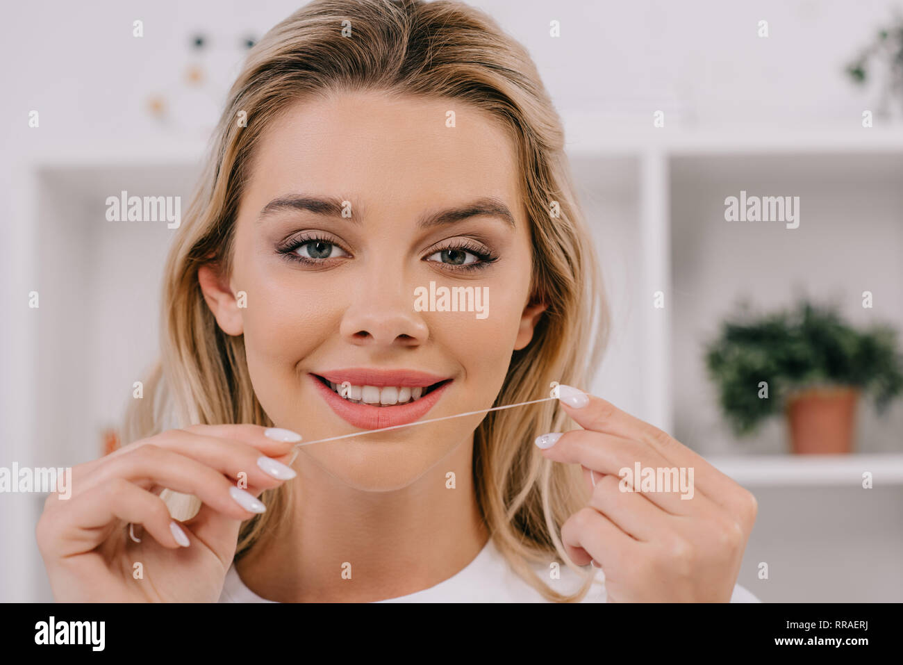 Young woman dental floss hi-res stock photography and images - Alamy
