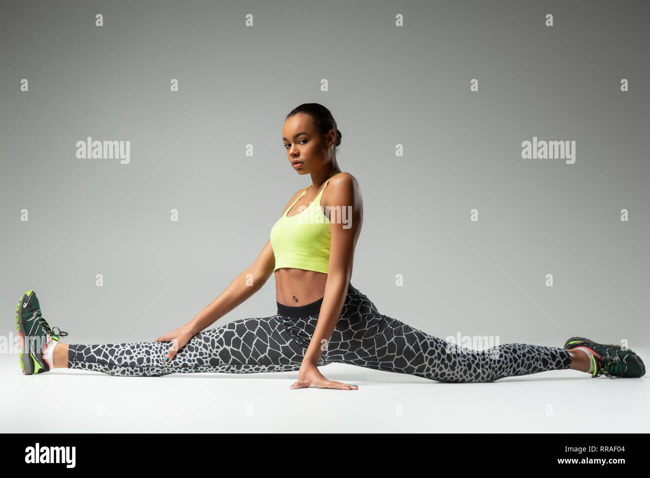Charming international female person doing the splits Stock Photo - Alamy