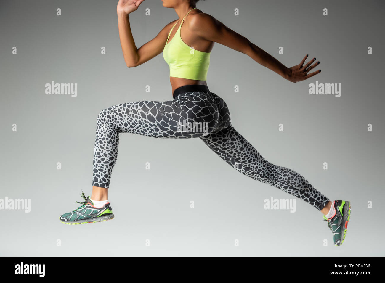 Healthy female person jumping high in studio Stock Photo - Alamy
