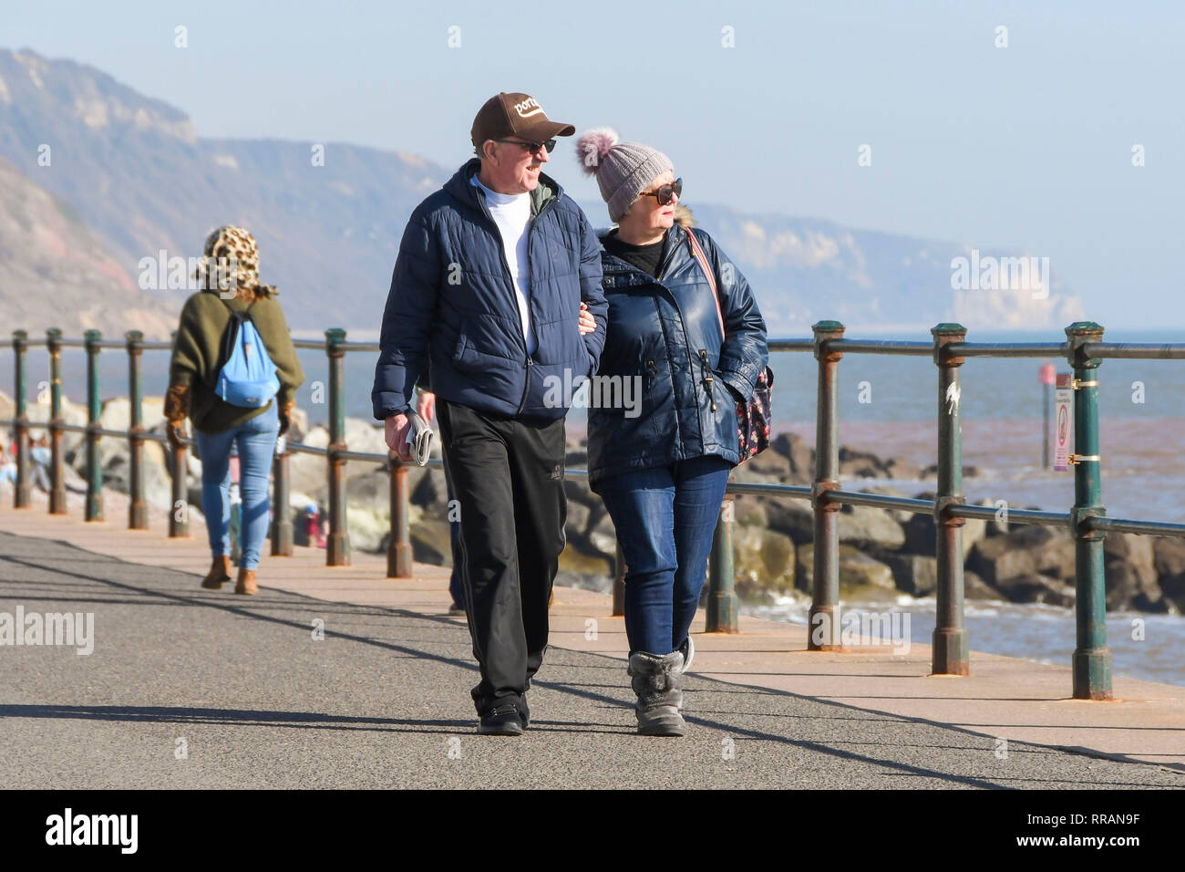 Sidmouth, Devon, UK. 25th February 2019. UK Weather. A couple walking ...