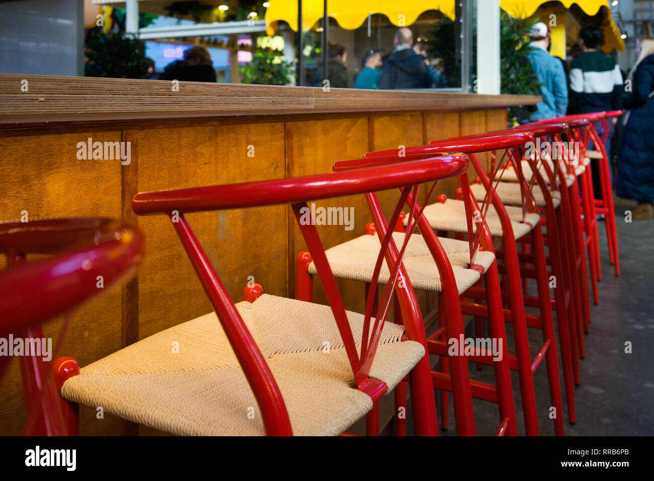 Red empty bar stools before opening Stock Photo - Alamy