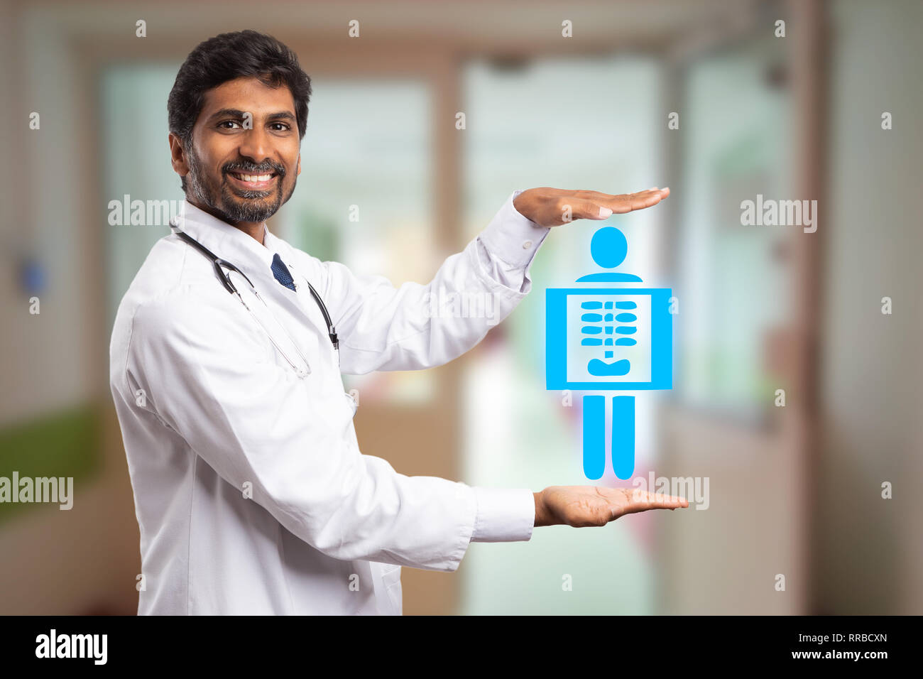 Male indian doctor with friendly expression presenting internal x-ray ...