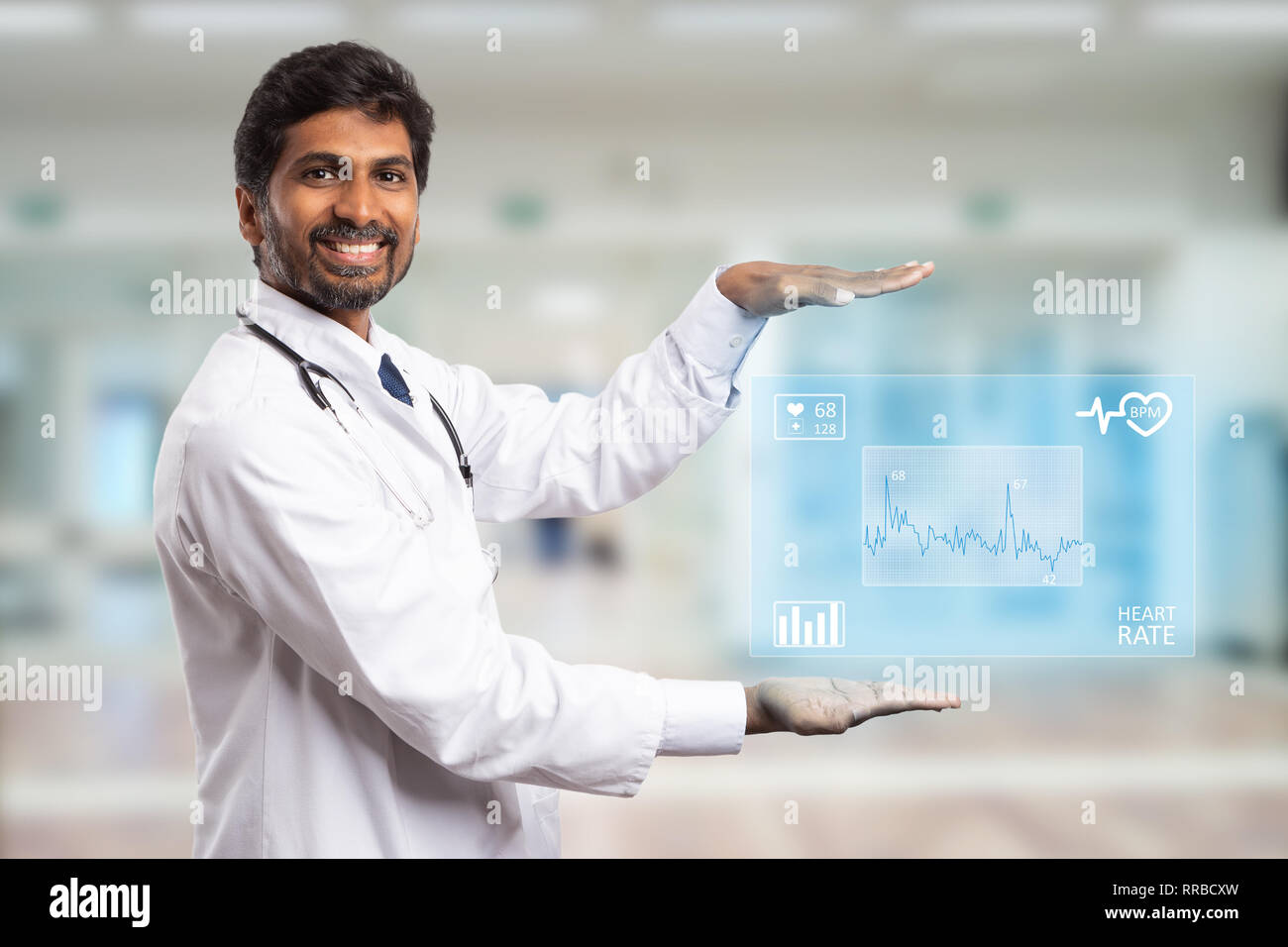 Smiling indian male cardiologist presenting heart monitoring ...