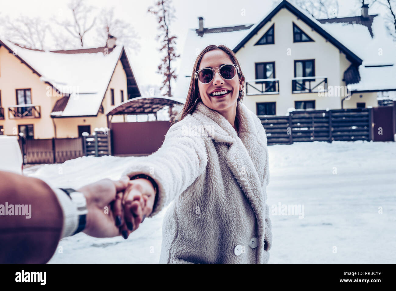 Young girlfriend feeling happy seeing snow walking with her man Stock ...