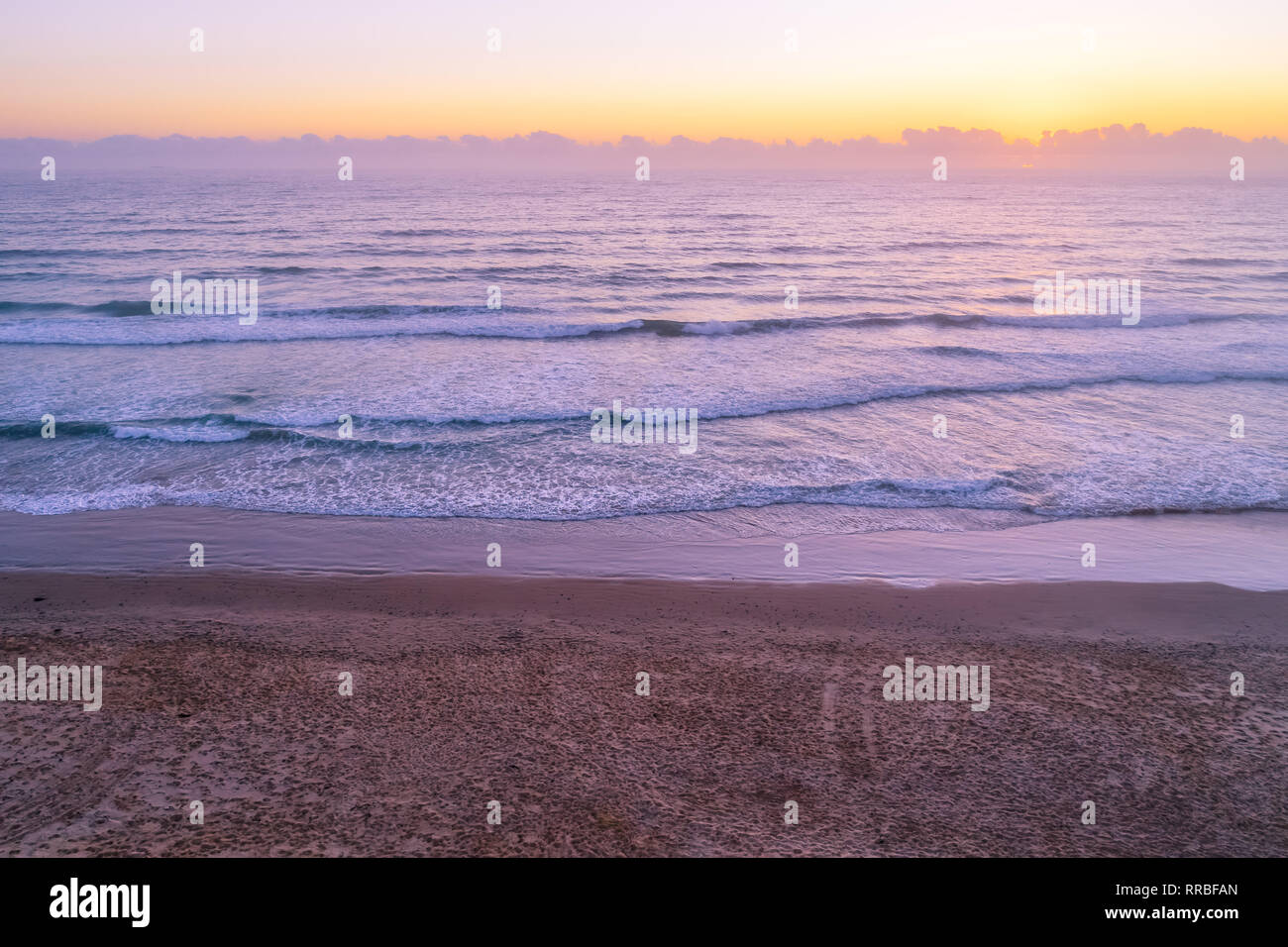 Sunrise over empty ocean beach with copy space Stock Photo - Alamy
