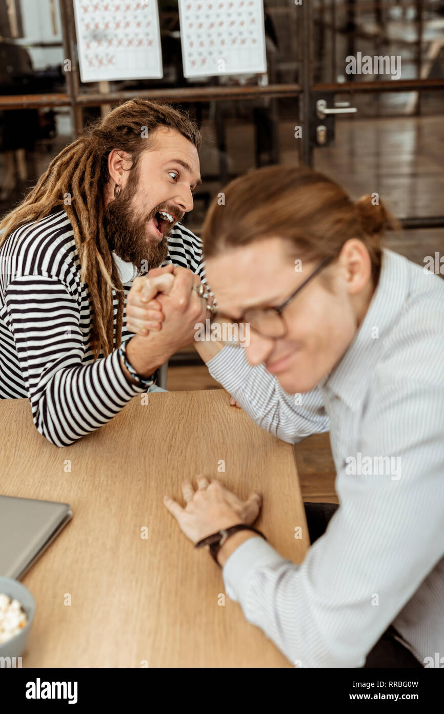 Nice emotional man putting all his strength Stock Photo - Alamy