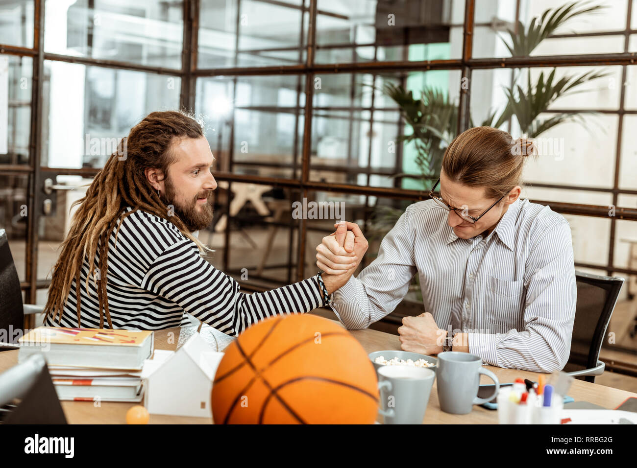 Nice young colleagues competing with each other Stock Photo - Alamy