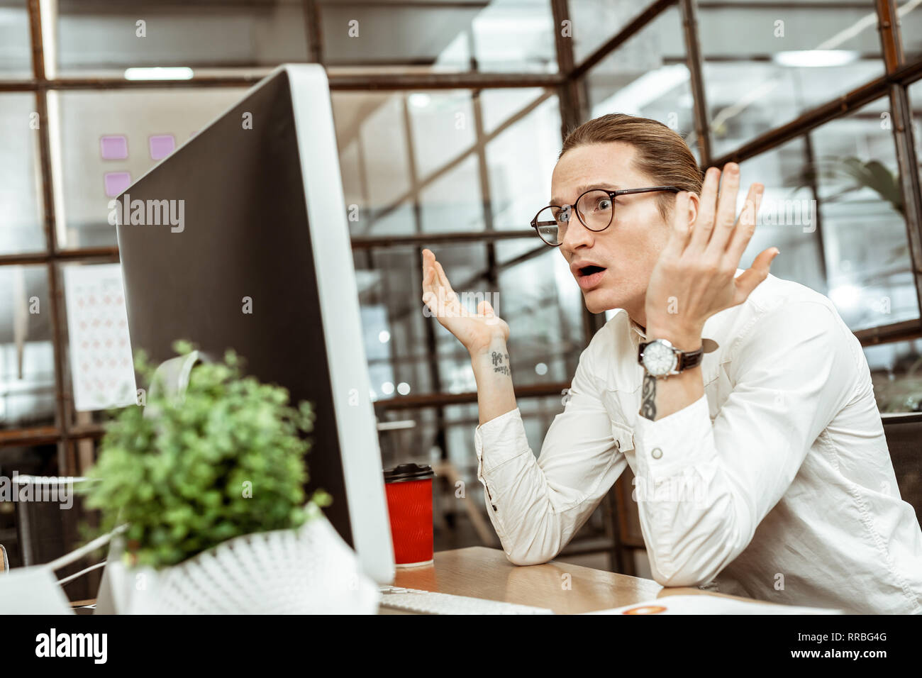 Emotional young man looking at the computer screen Stock Photo - Alamy