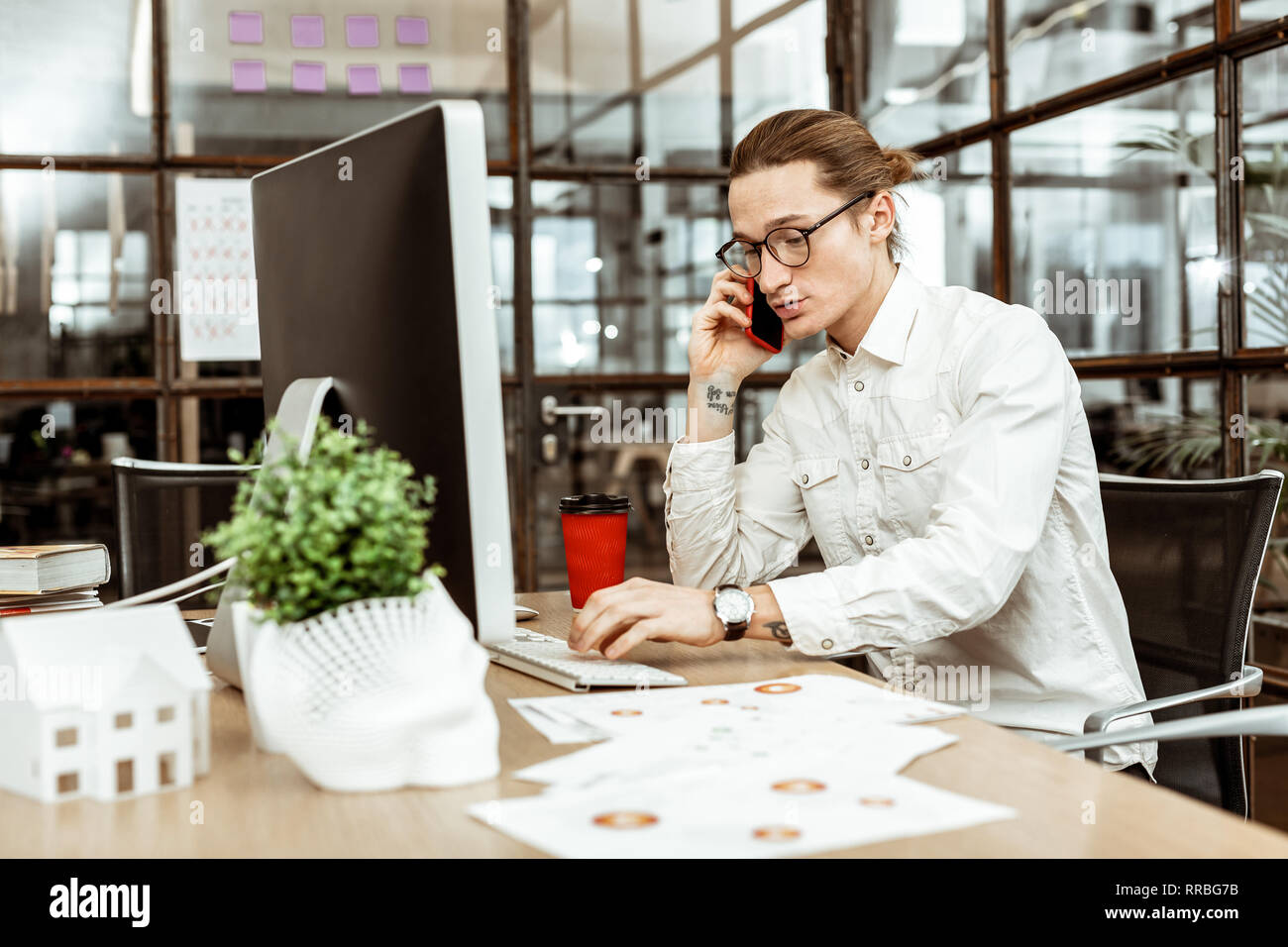 Serious handsome man speaking on the phone Stock Photo - Alamy