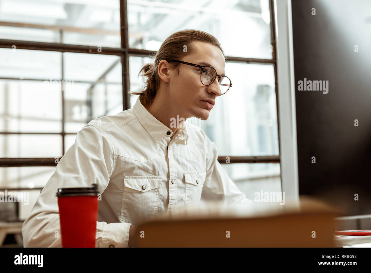 Handsome good looking man focusing on work Stock Photo - Alamy