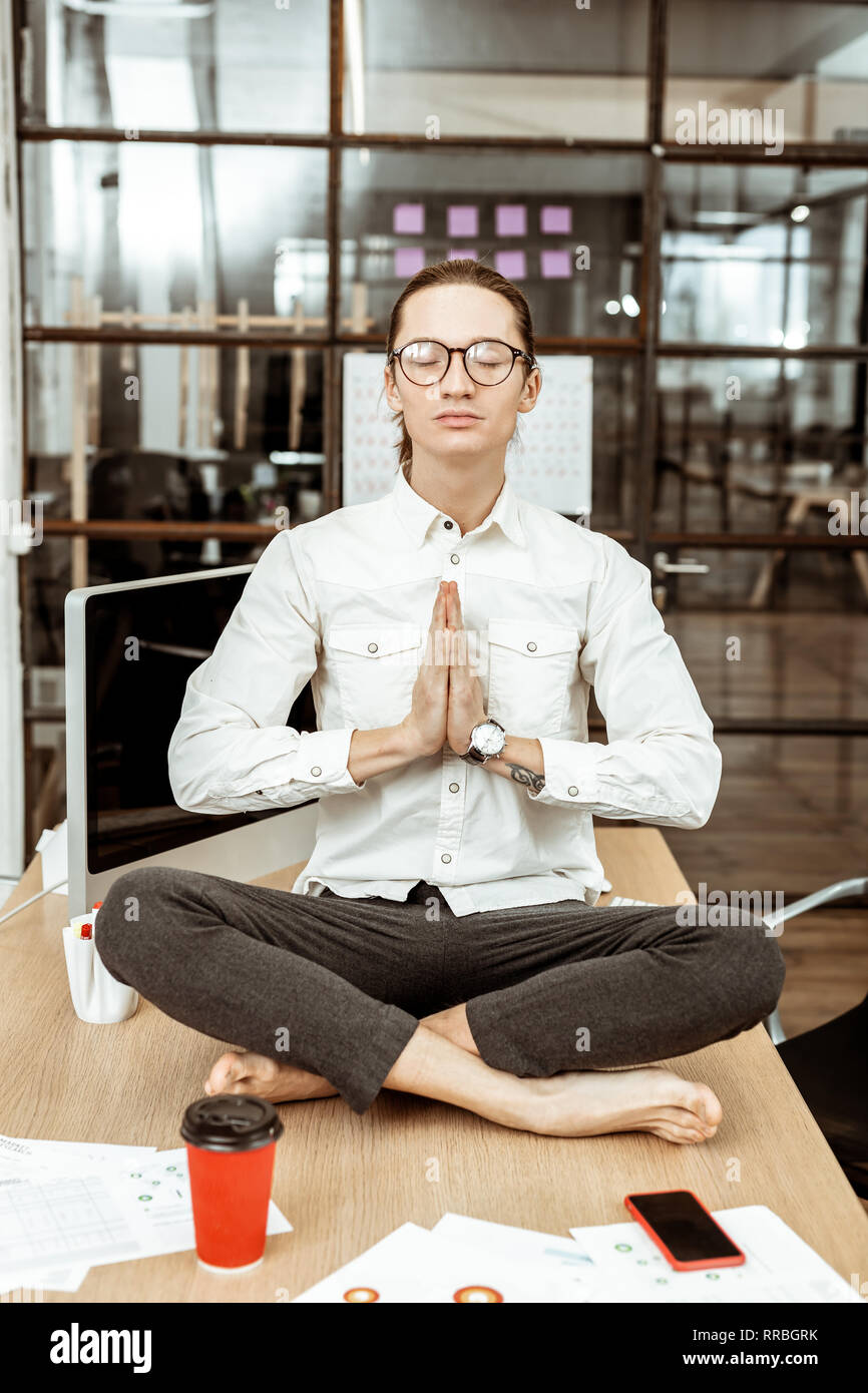 Handsome calm man sitting with his eyes closed Stock Photo - Alamy