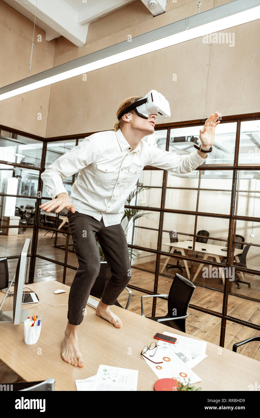 Nice young man being in virtual reality Stock Photo - Alamy