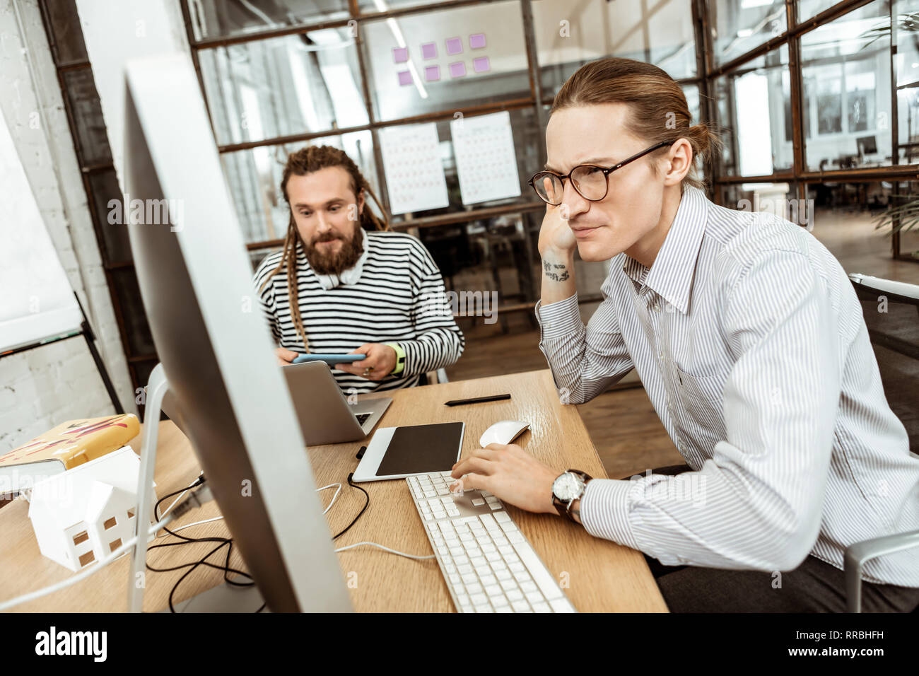 Serious focused man thinking about his work Stock Photo - Alamy