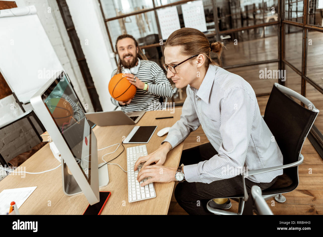 Serious blonde young man typing the text Stock Photo - Alamy