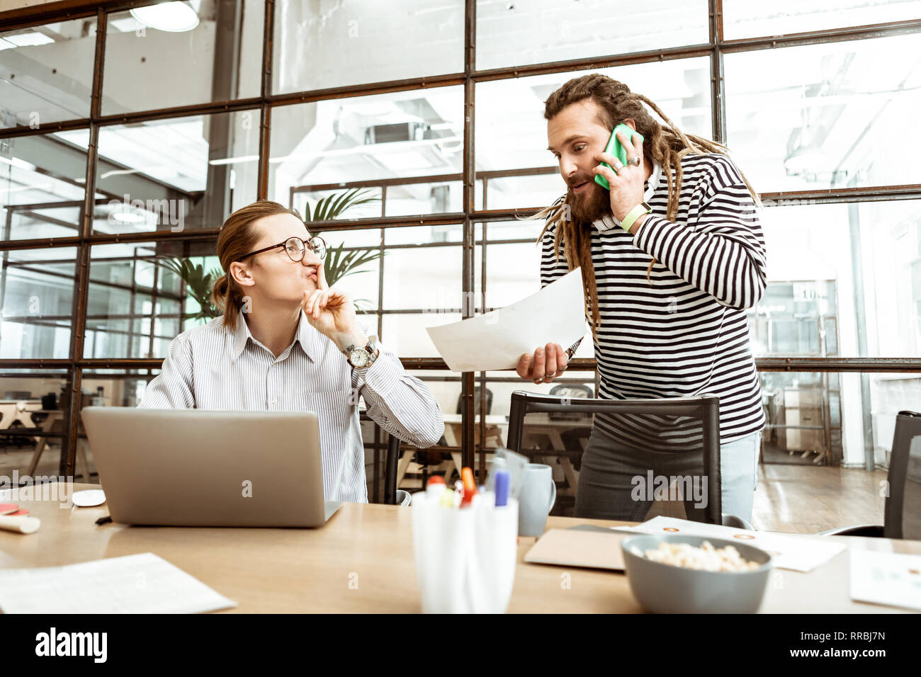 Nice bearded man having a phone conversation Stock Photo - Alamy