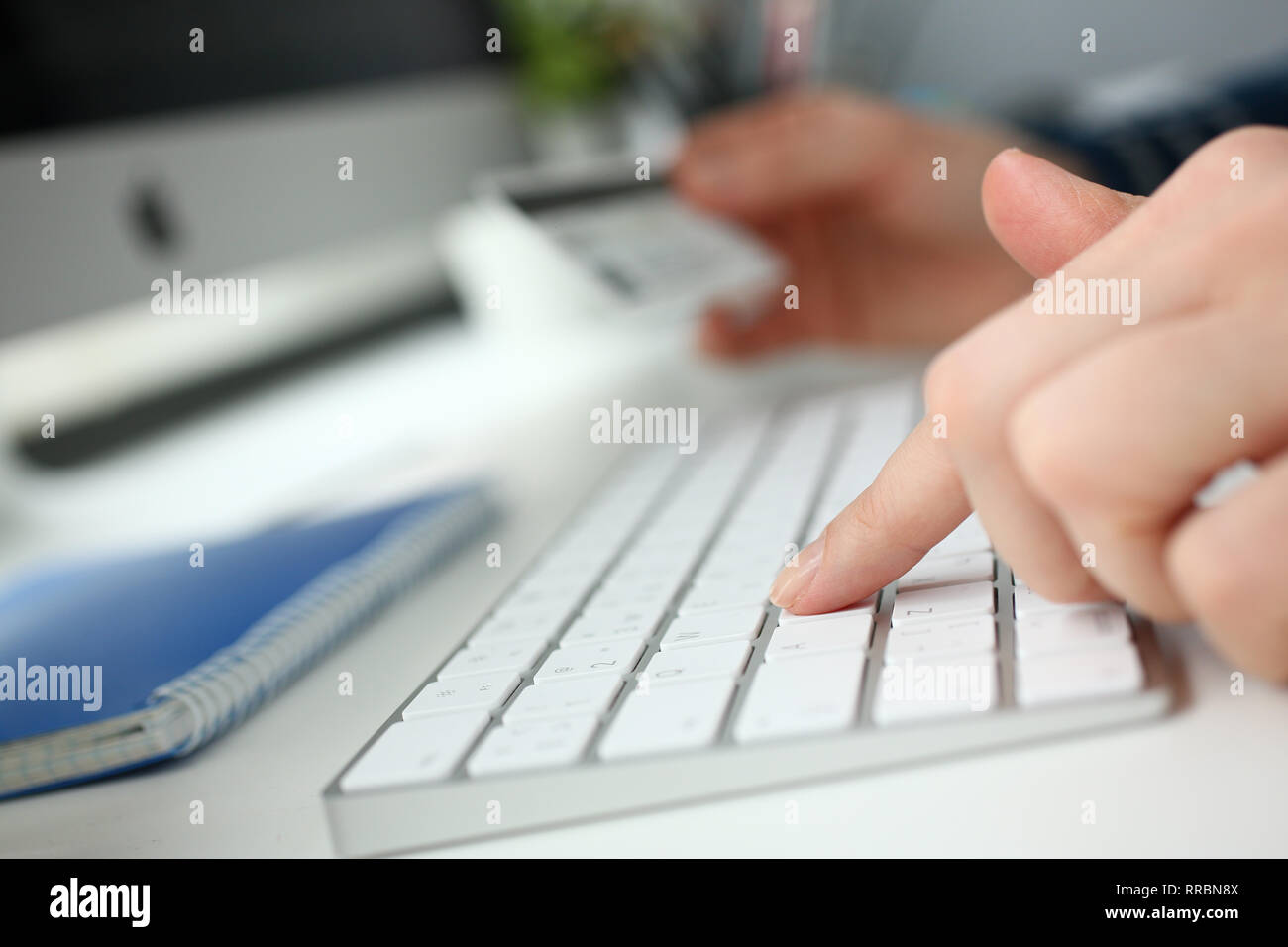 Female arms hold credit card press buttons Stock Photo - Alamy