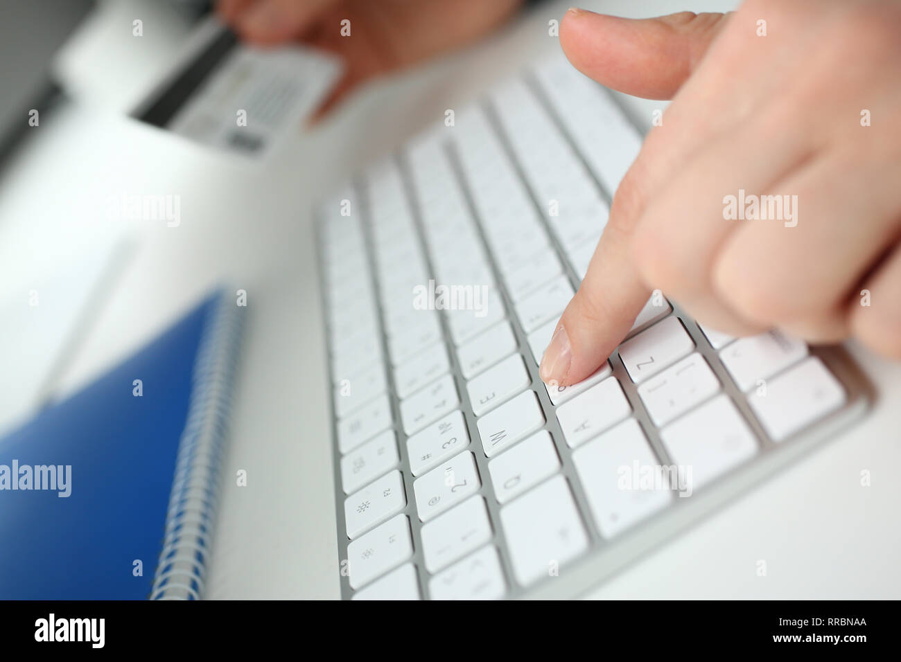 Female arms hold credit card press buttons Stock Photo - Alamy