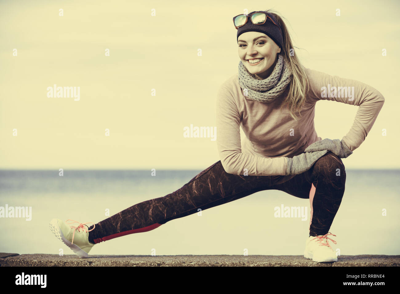 Woman athlete girl training wearing warm sporty clothes outside by ...