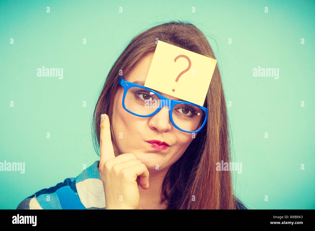 Thinking woman with big nerdy eyeglasses and question mark on forehead ...