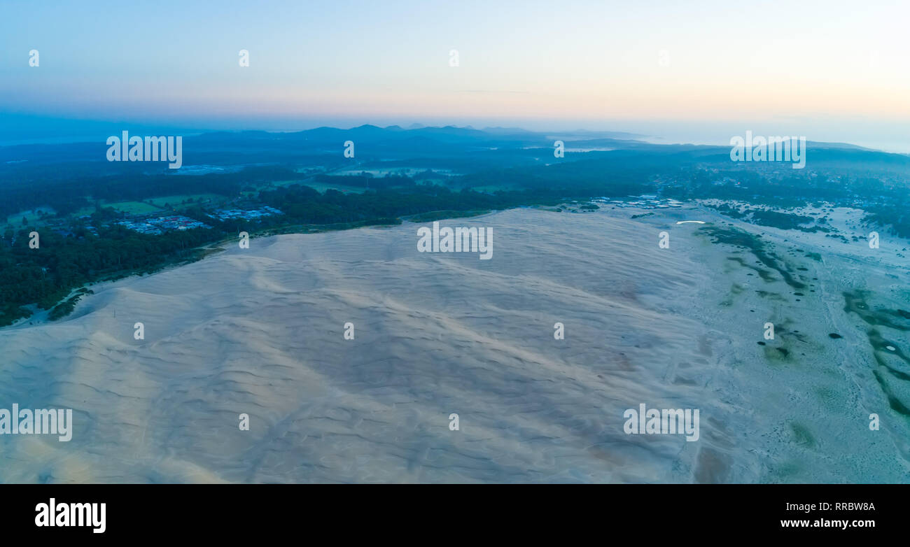 Aerial panorama of ocean coastline and famous landmark sand dunes. Anna ...
