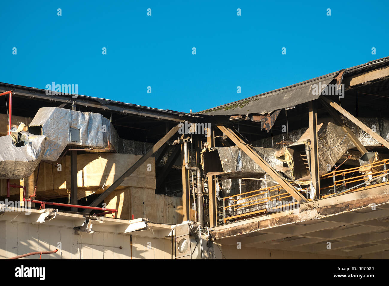 Damaged factory roof clear blue sky background Stock Photo - Alamy