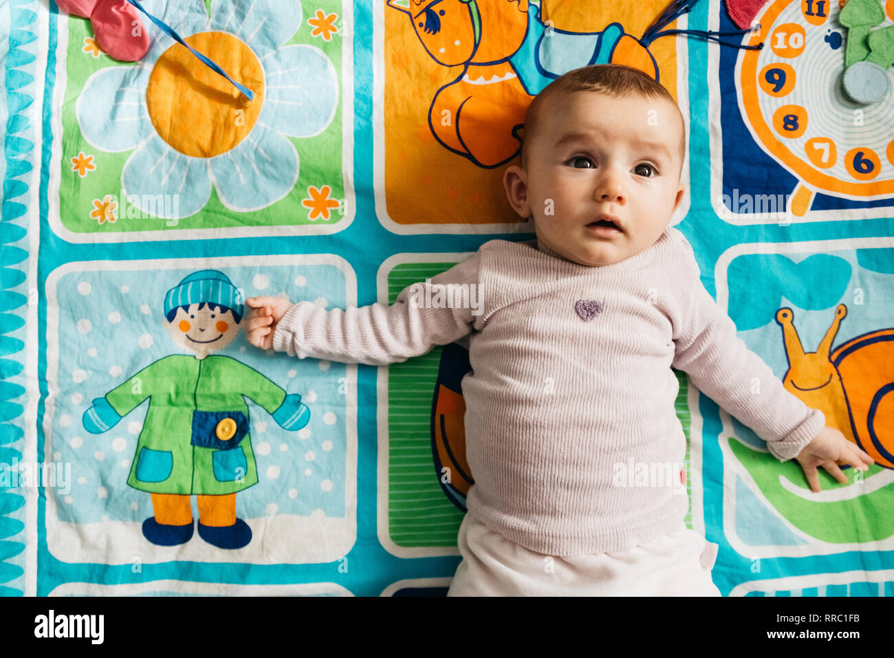 Baby smiling with laughter on a mat of early stimulation Stock Photo ...
