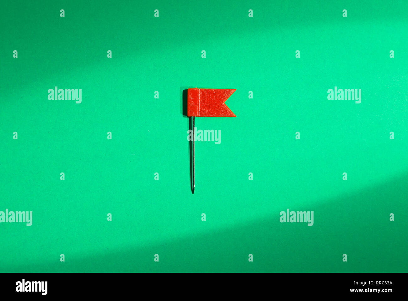 Red little flag pin on a green background. View from above Stock Photo ...