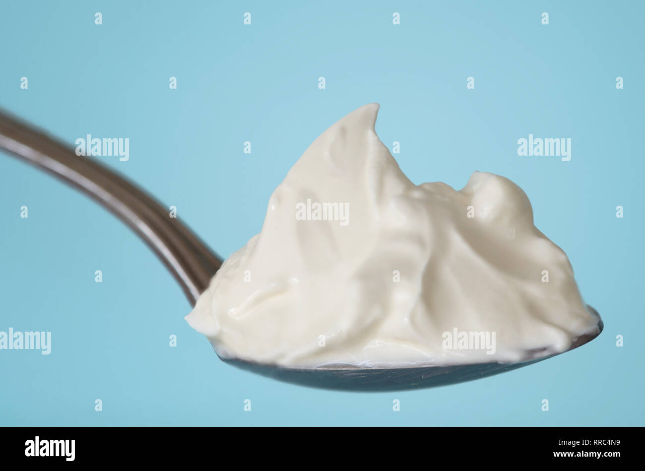 Spoon of Fresh yogurt in mountain shape Stock Photo - Alamy