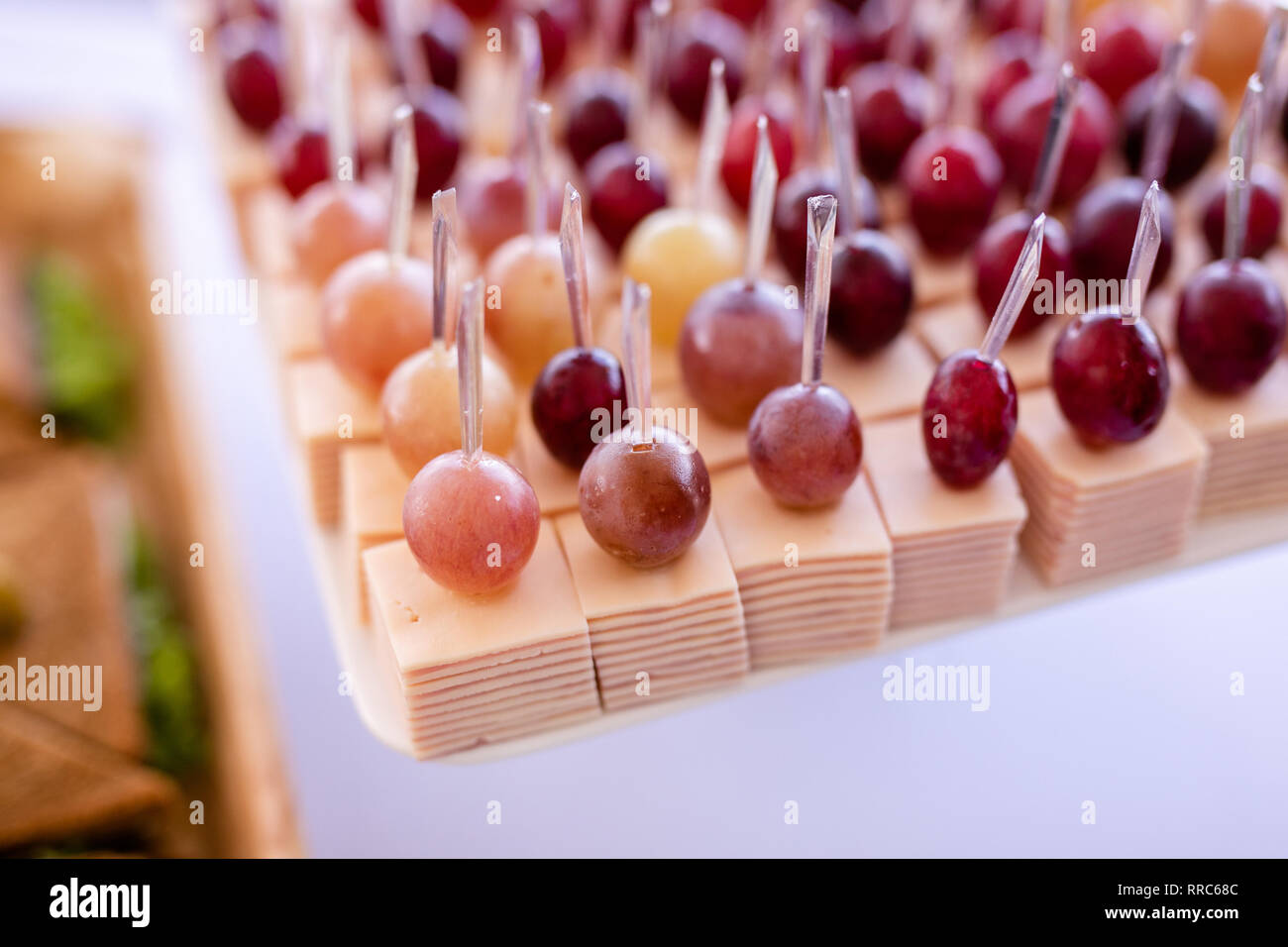 Light snacks in a plate on a buffet table. Assorted mini canapes ...