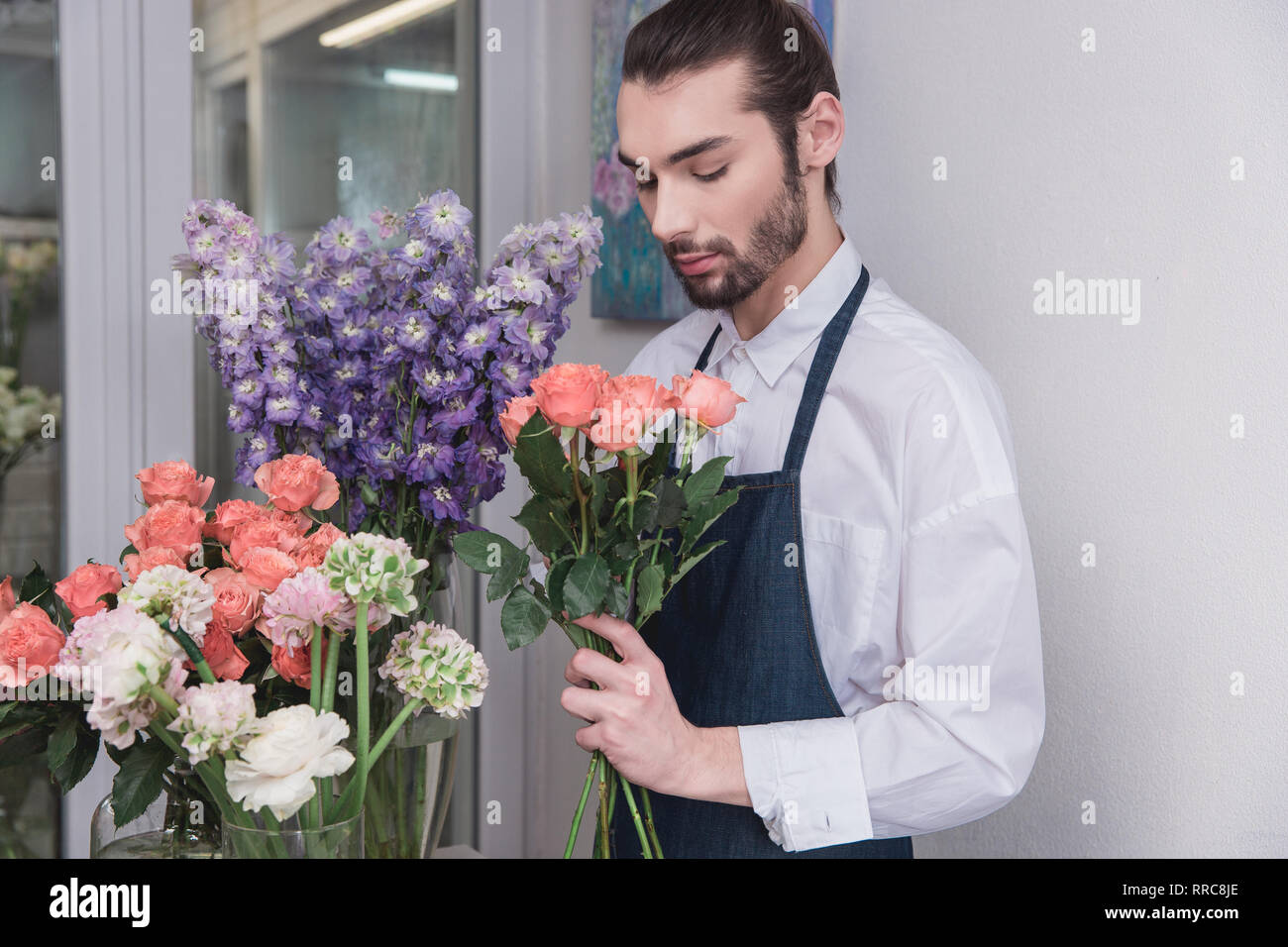 Small business. Male florist in flower shop. Floral design studio ...