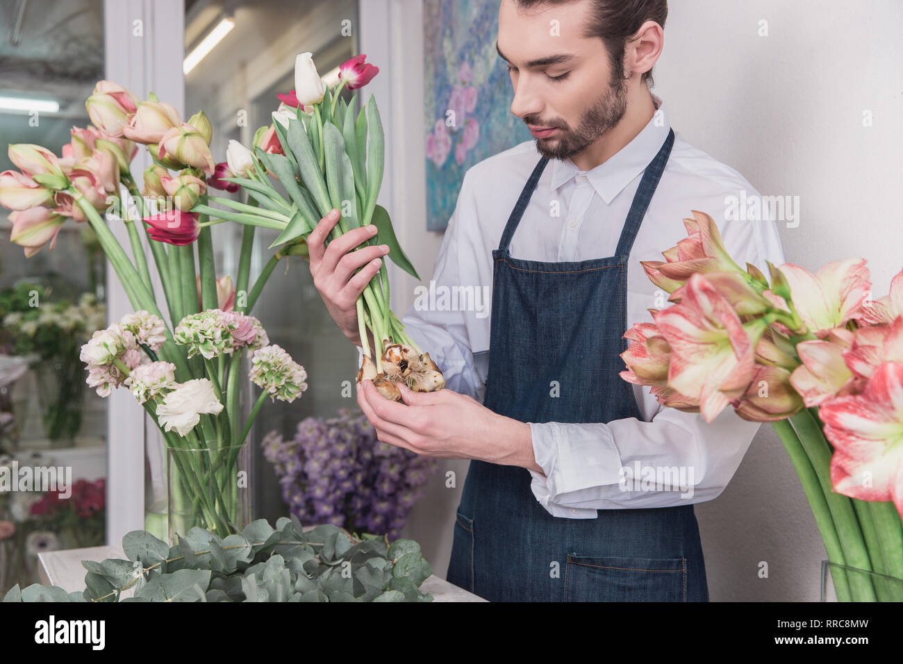 Small business. Male florist in flower shop. Floral design studio ...