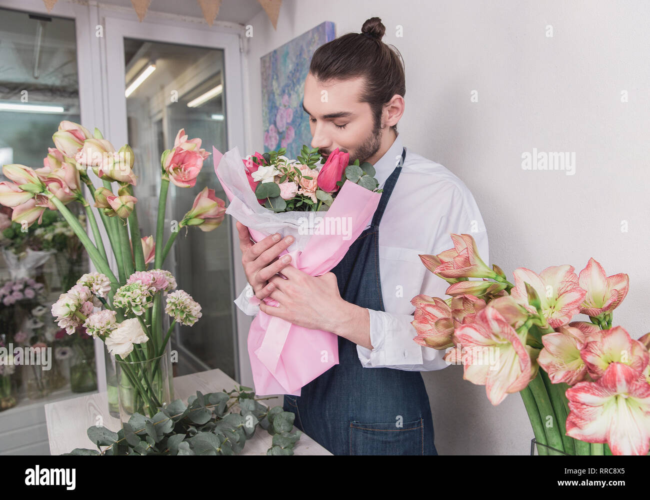 Small business. Male florist in flower shop. Floral design studio ...