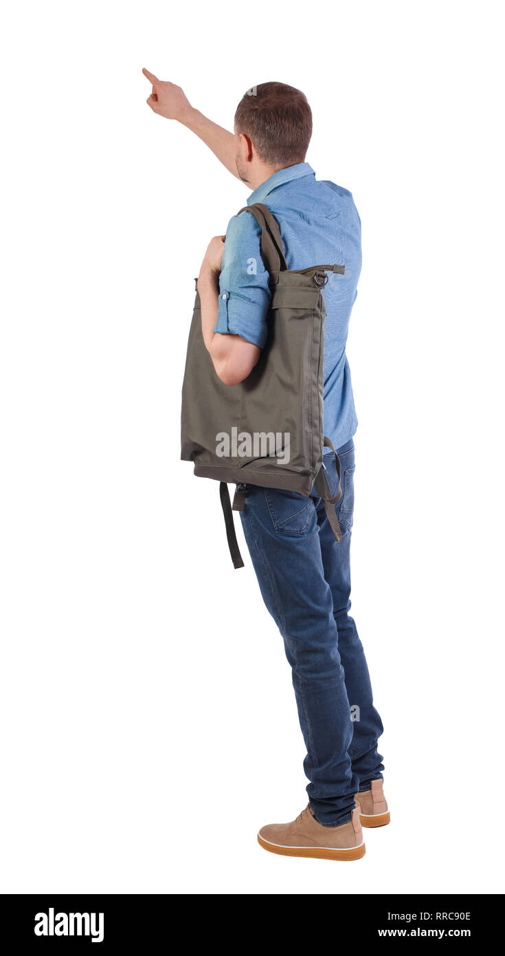 Back view of a man with a green backpack pointing forward. backside ...