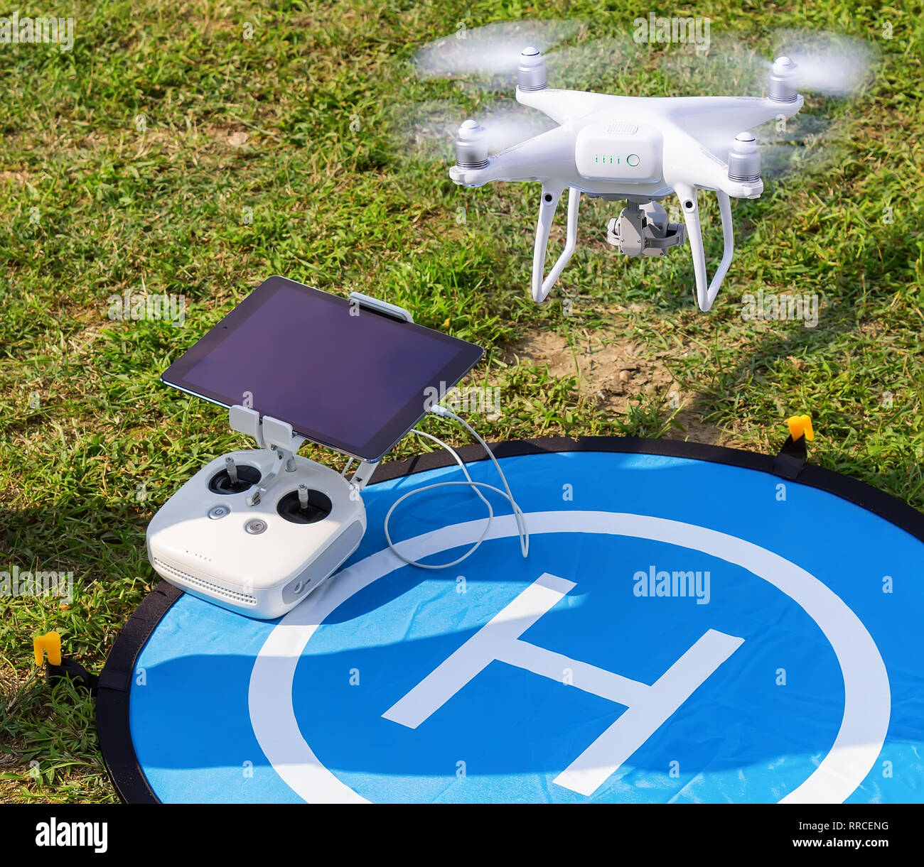 Remote control with a tablet and take-off drone from the landing site ...