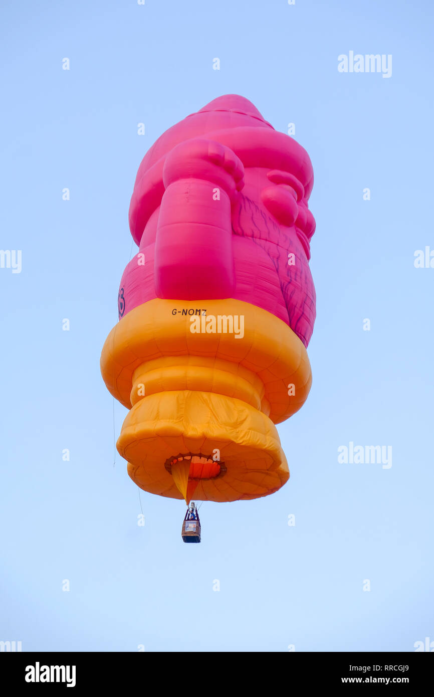 A decorated and elaborated hot air balloon rising with a blue sky ...