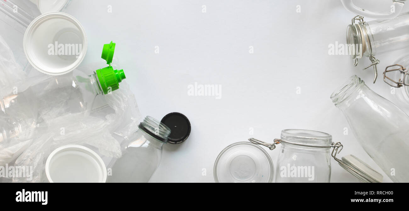 many different empty glass and plastic bottles lying on a white ...