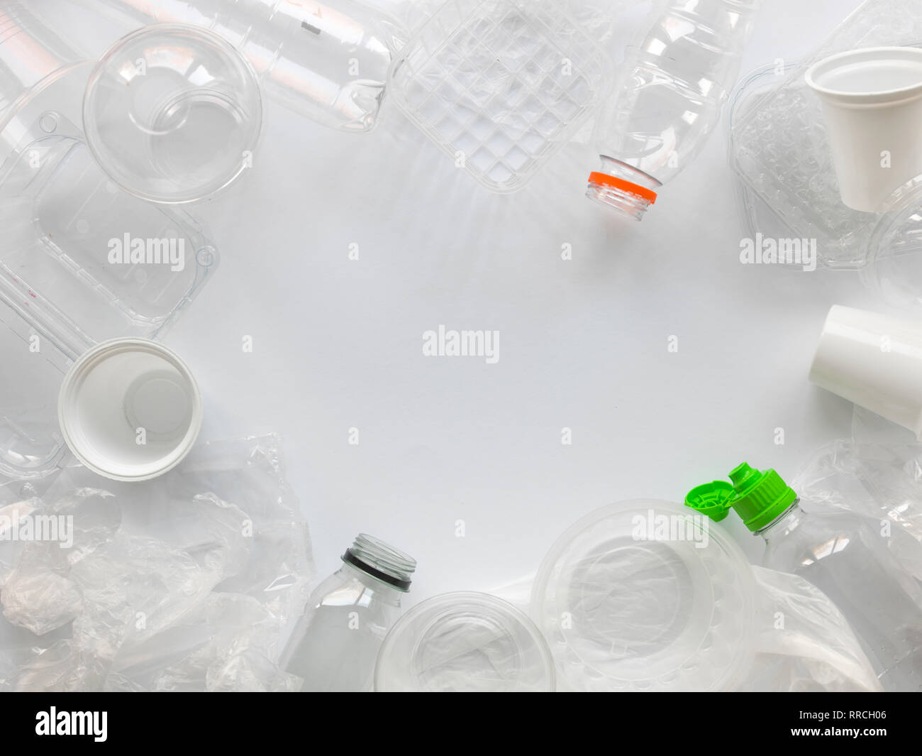 many different empty plastic bottles and packages lying on a white ...