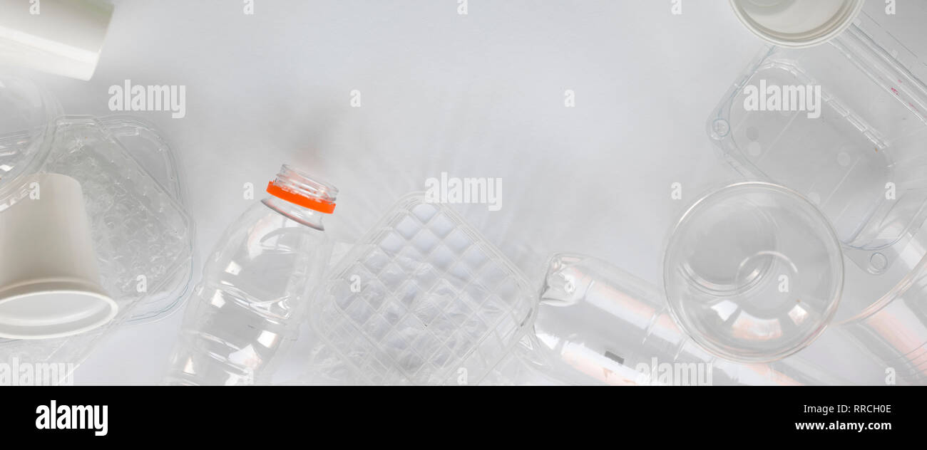 many different empty plastic bottles and packages lying on a white ...