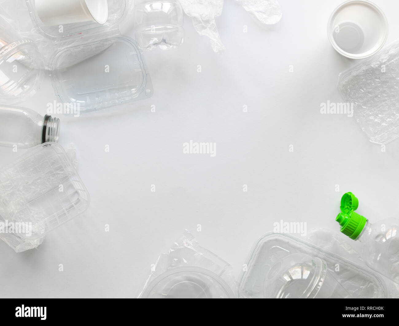 many different empty plastic bottles and packages lying on a white ...