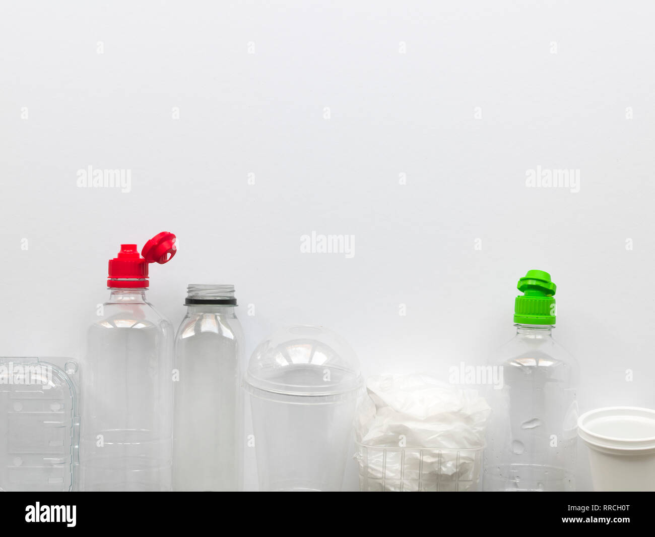 many different empty plastic bottles and packages lying on a white ...